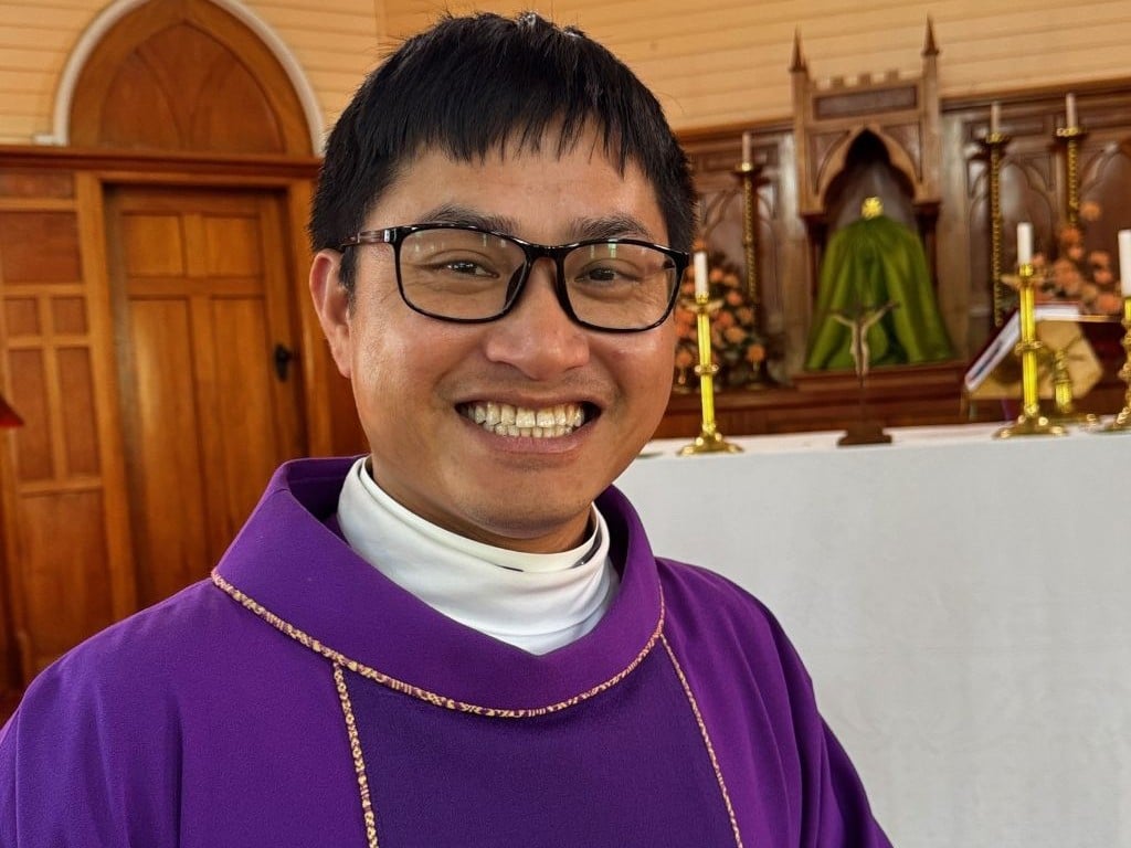 Smiling Vietnamese priest ministers below Mt Ruapehu - CathNews New Zealand